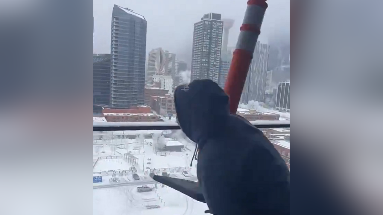 Woman charged after video shows pylon thrown from balcony